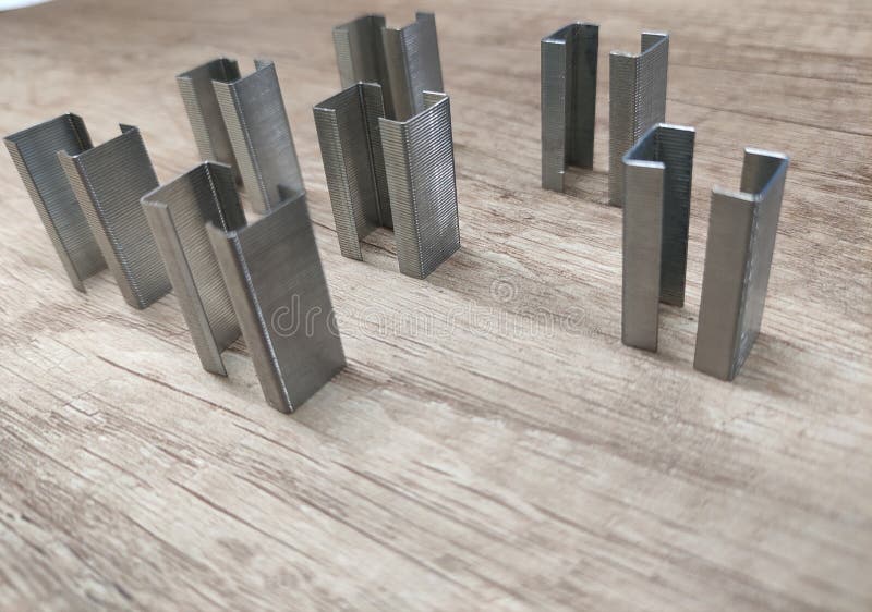 A Figure Resembling a Skyscraper Made of Paper Clips on a Wooden Table ...