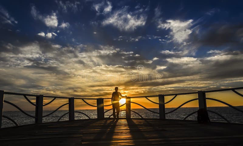 Figure Under the Setting Sun Stock Image - Image of water, sunshine ...