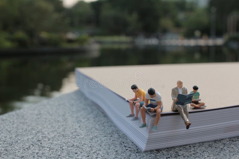 Figures Reading and Relaxing on a Giant Book Stock Photo - Image of ...