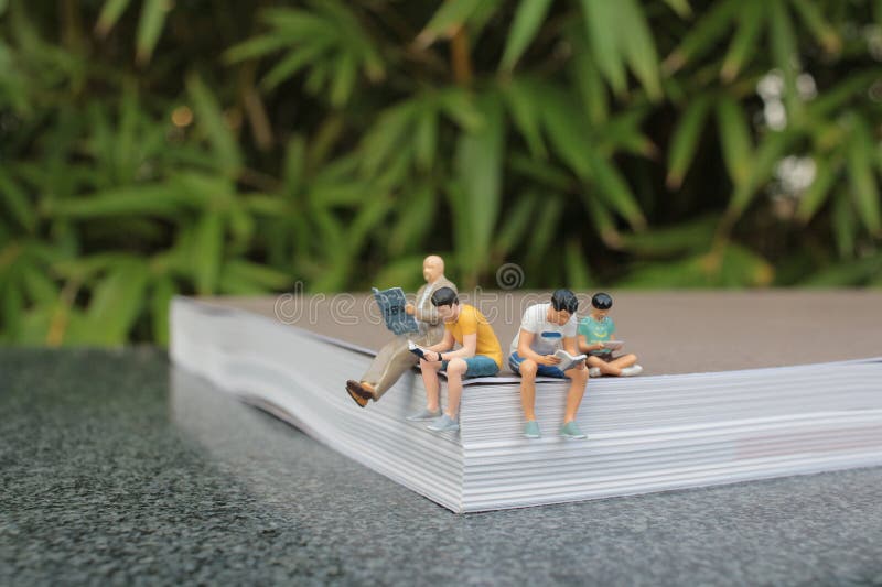Figures Reading and Relaxing on a Giant Book Stock Photo - Image of ...