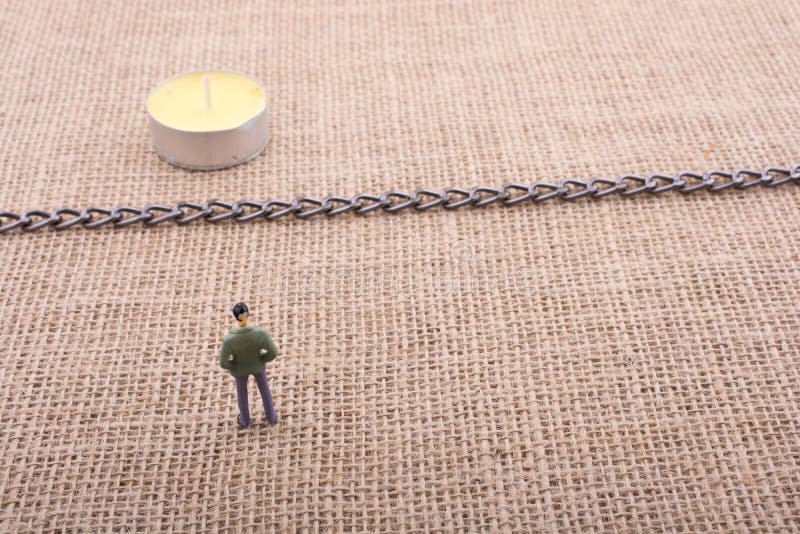 Figurine and Candle with a Chain in the Middle Stock Image - Image of ...