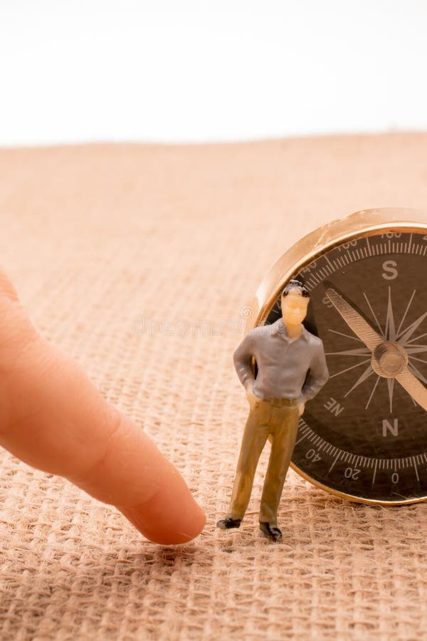 Figurine by the Side of a Compass Stock Photo - Image of natural ...