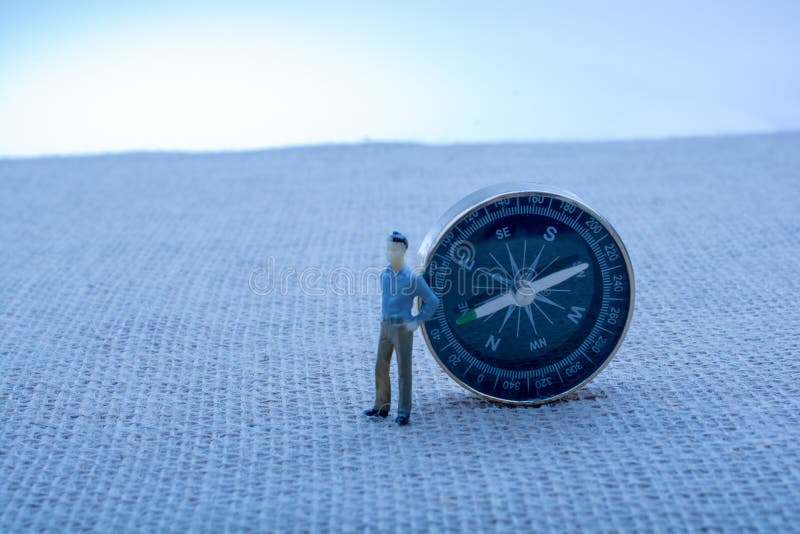Figurine by the Side of a Compass Stock Image - Image of guidance ...