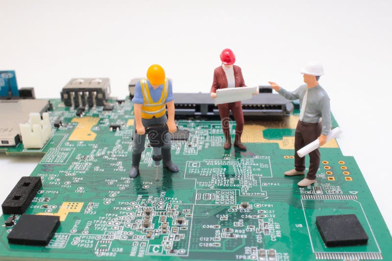 Miniature Engineers Working on a Circuit Board Construction Project ...
