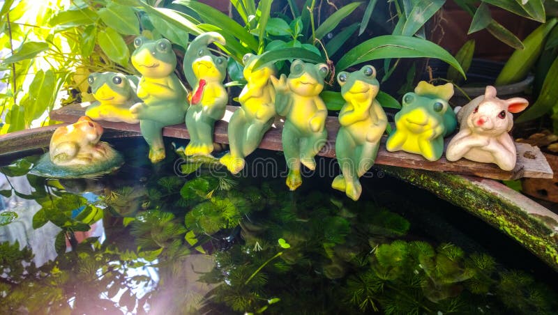 Figurines of Frogs and Rabbit on the Fish Pond. Stock Image - Image of ...