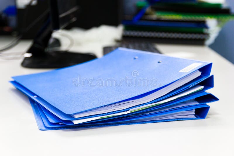 File Folder and Stack of Business Report Paper File on Desk in Office ...