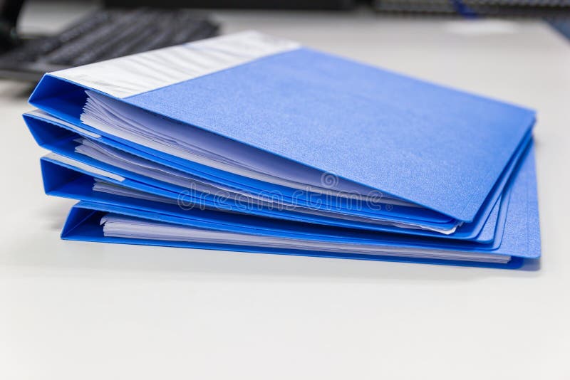File Folder and Stack of Business Report Paper File on Desk in Office ...