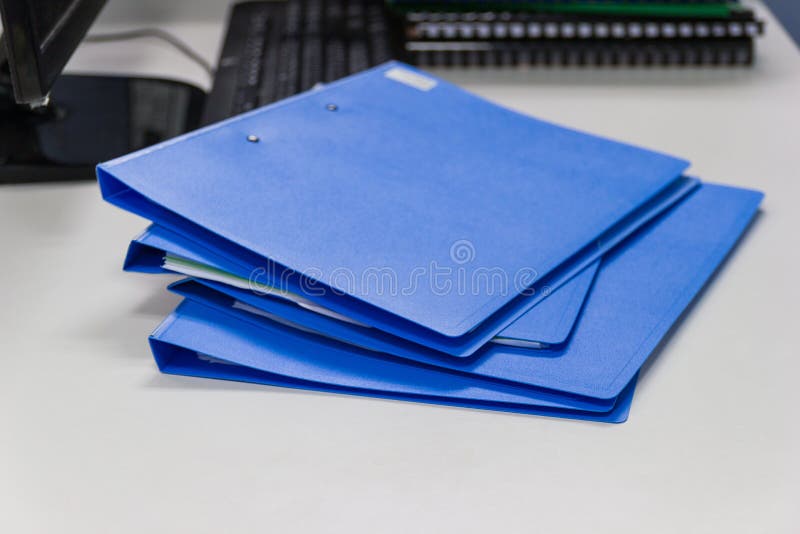 File Folder and Stack of Business Report Paper File on Desk in Office ...