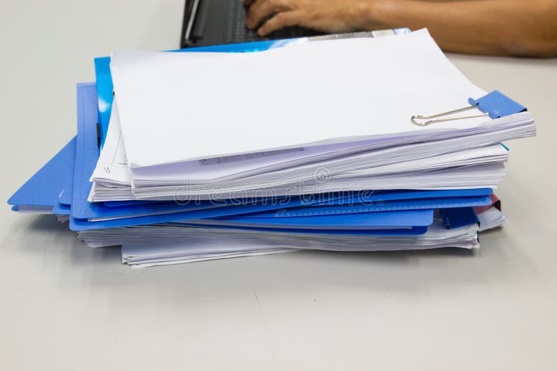 File Folder and Stack of Business Report Paper File on the Table in a ...