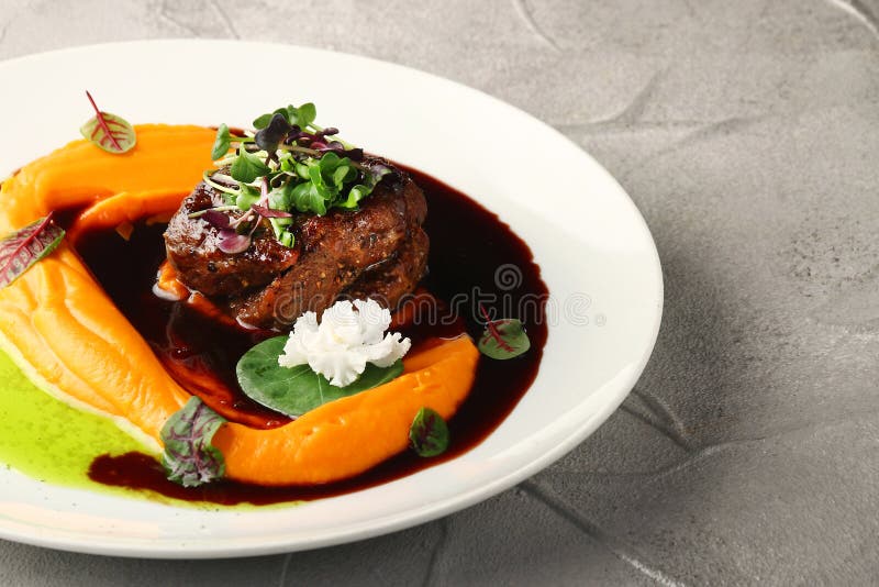 Filet Mignon with Mashed Pumpkin and Microgreen in White Plate on ...