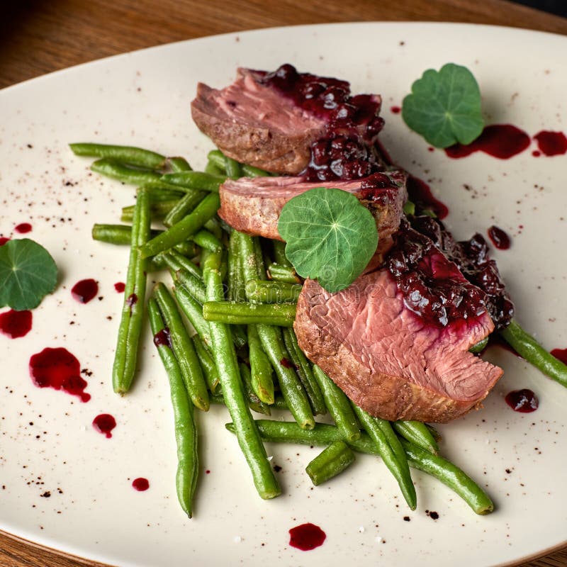 Filet Mignon Steak Dinner with Green String Beans Ion a White Plate ...