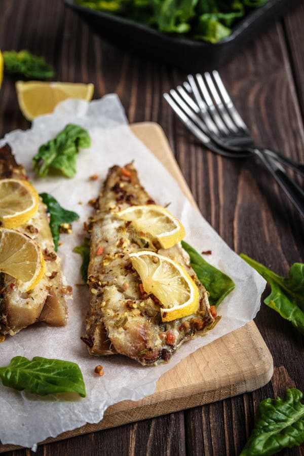 Filete De Pollock Cozido Com Limão E Espinafre Sobre Fundo De Madeira ...