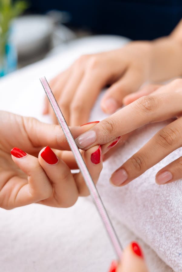 Manicurist Filing Nails Of Her Female Client. Stock Image - Image of ...