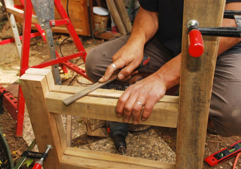 Filing a Wooden Chair Frame Stock Photo - Image of exterior, shorts ...