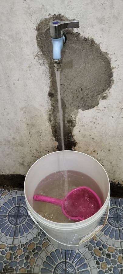 Fill the Large White Bucket with Water from the Water Tap in the ...