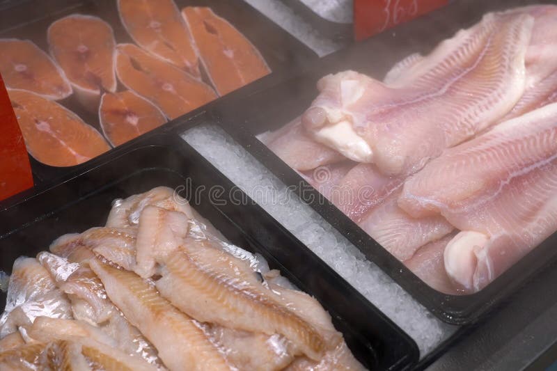 A Fillet of Fresh Fish Rests on an Icy Counter in the Store Under a ...