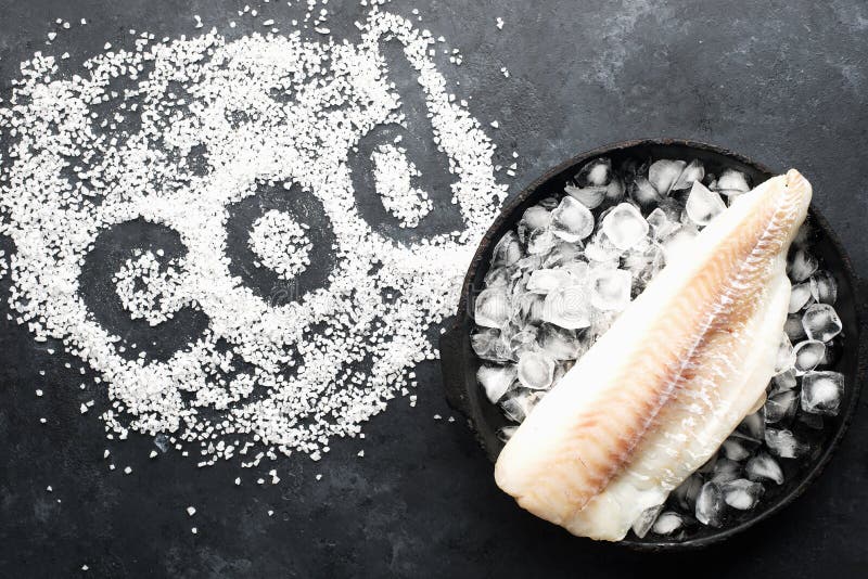 Fillet of White Sea Cold-water Fish Cod in Ice Cubes on a Dark ...