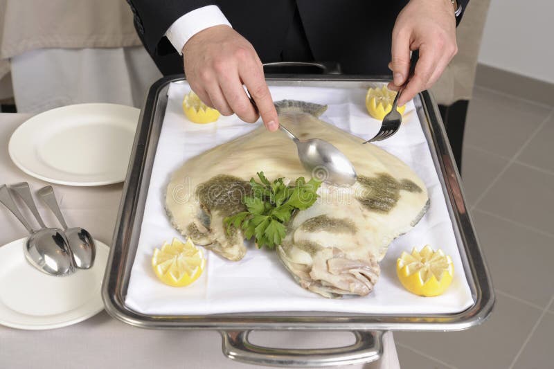 Filleting a poached turbot stock image. Image of rise - 23707489