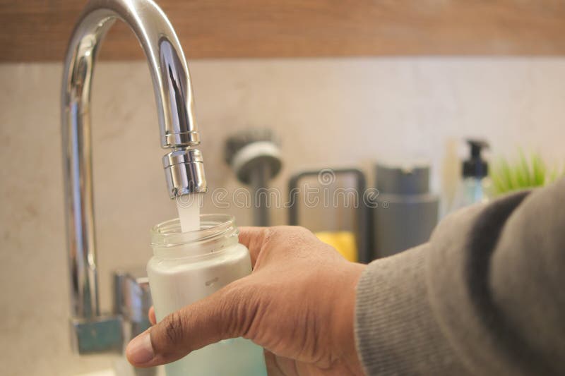 Filling a Bottle with Water from a Faucet Using Hand Gestures Stock ...