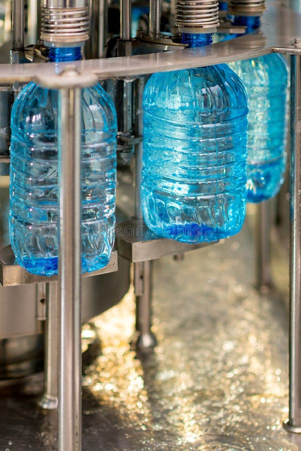 Filling bottles with water stock photo. Image of heavy - 86134356