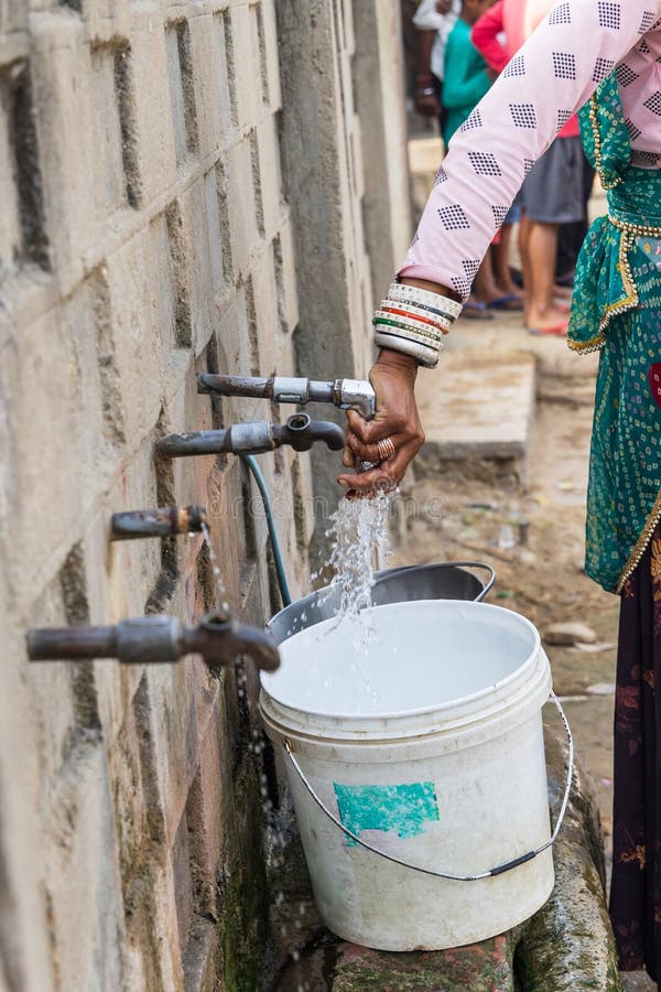 Filling a Bucket with Drinking Water at a Public Tap Stock Photo ...