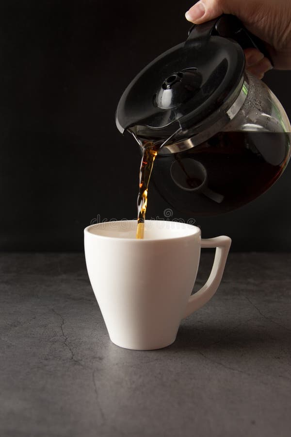 Filling a Coffee Cup with Coffee in Slow Motion Stock Photo - Image of ...