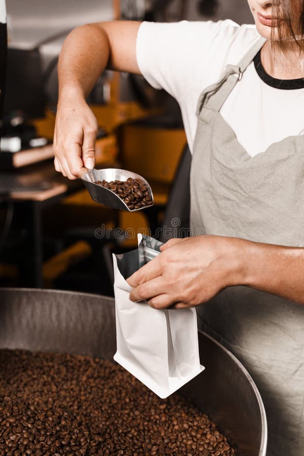 Filling Coffee Grains in a Craft Bag. Packing Fried Coffee Beans ...