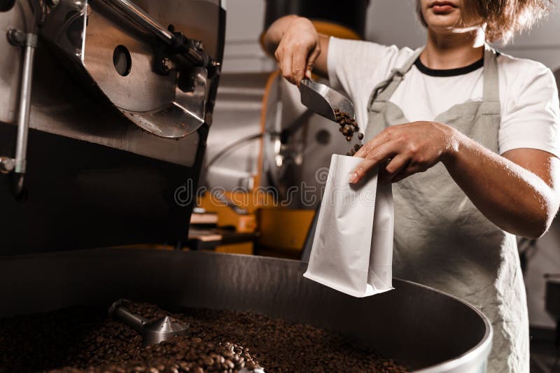 Filling Coffee Grains in a Craft Bag. Packing Fried Coffee Beans ...