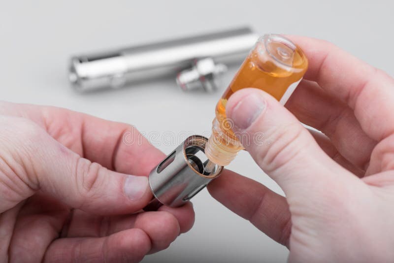 Filling of e-cig atomizer stock photo. Image of manual - 70235998