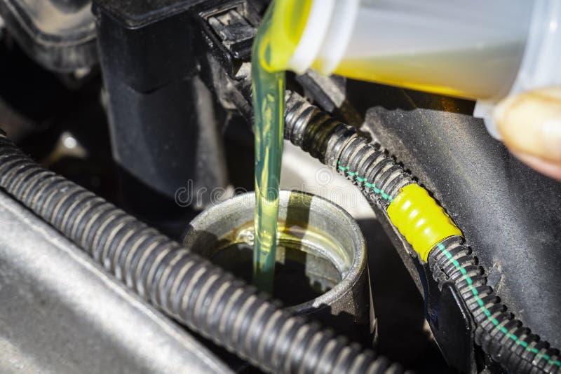 Pouring oil in the engine stock photo. Image of close - 145173028