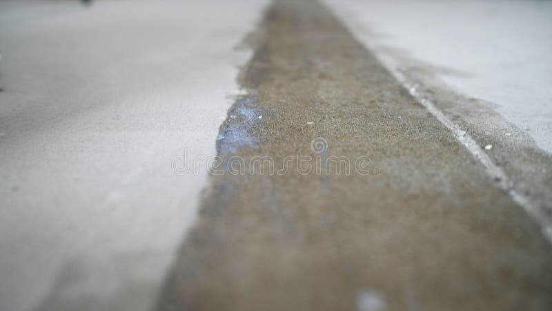 Filling Floor Joint with Self-leveling Concrete Mix Creating Smooth ...