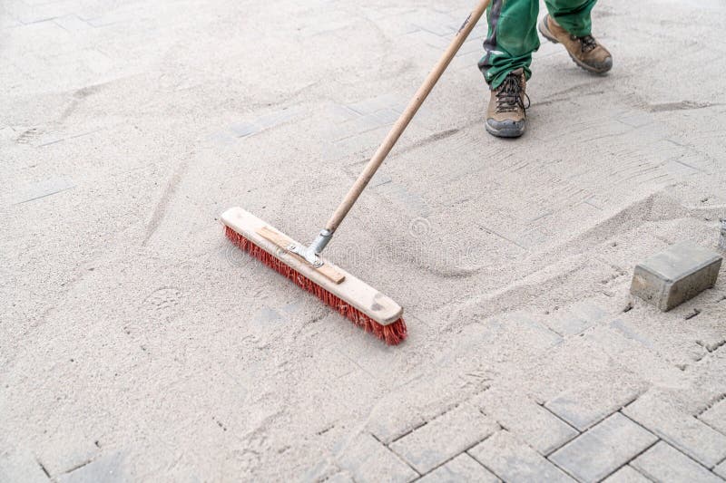 Filling the Gaps in the New Pavement with Sand Stock Image - Image of ...