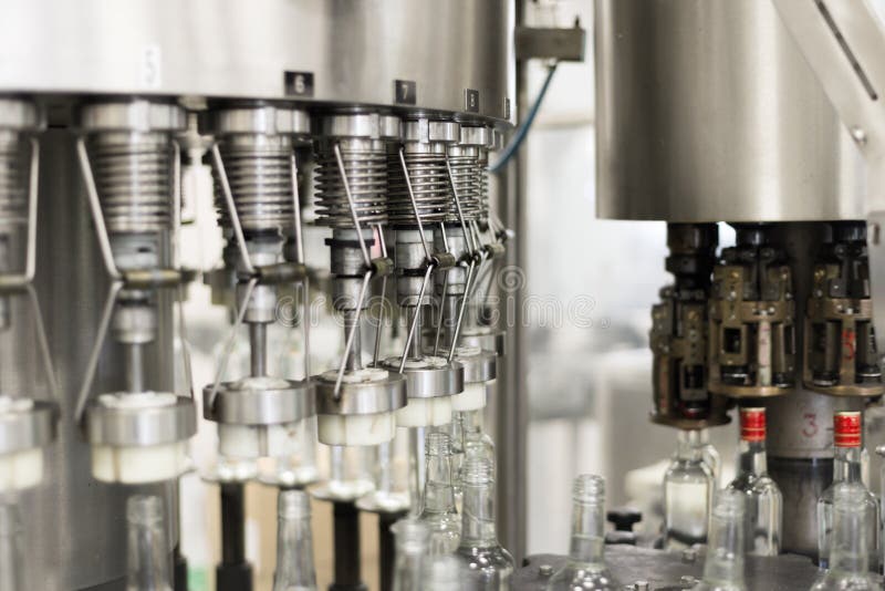Filling Glass Bottles with Liquid. Stock Photo - Image of manufacturing ...