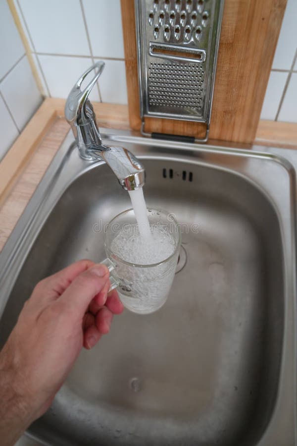 Filling a Glass with Tap Water for Drinking by Holding it in Man Hand ...