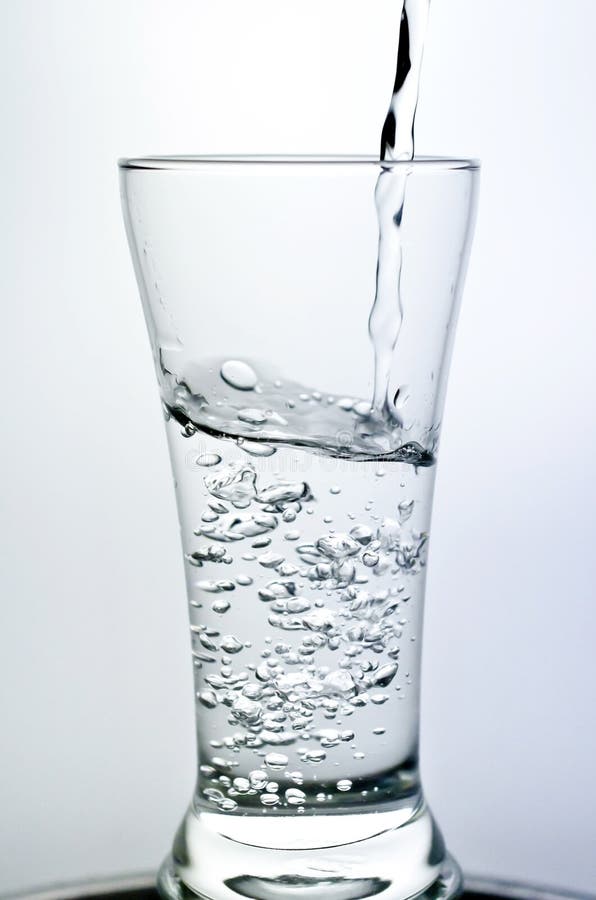 Filling a Glass with Water Showing a Drink Concept Stock Photo - Image ...