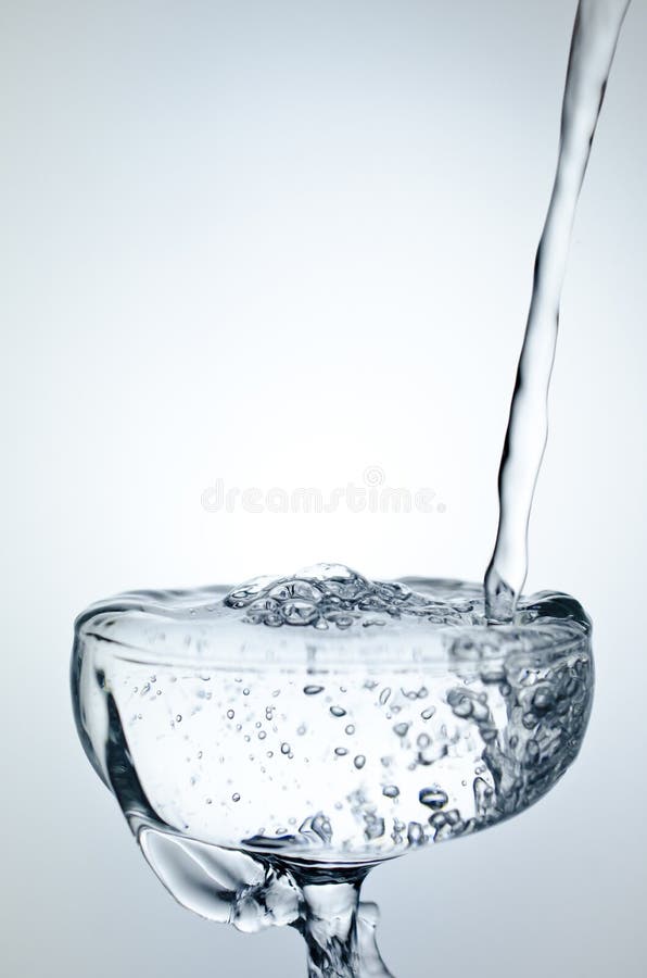 Filling a Glass with Water Showing a Drink Concept Stock Photo - Image ...