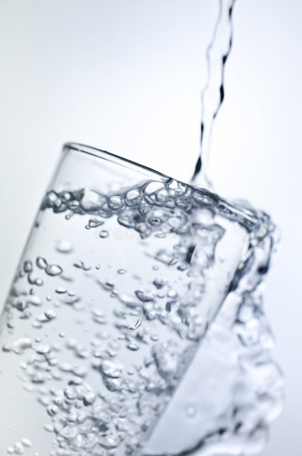 Filling a Glass with Water Showing a Drink Concept Stock Photo - Image ...