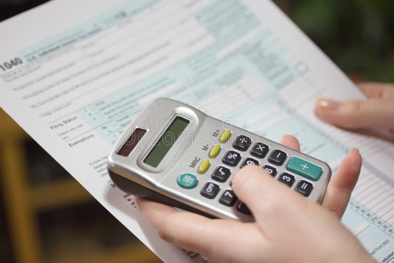 Filling Income Tax Forms with Calculator Stock Image - Image of person ...