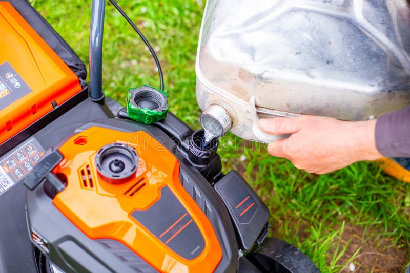 Filling a Petrol Lawn Mower with Fuel from a Canister. Preparing the ...