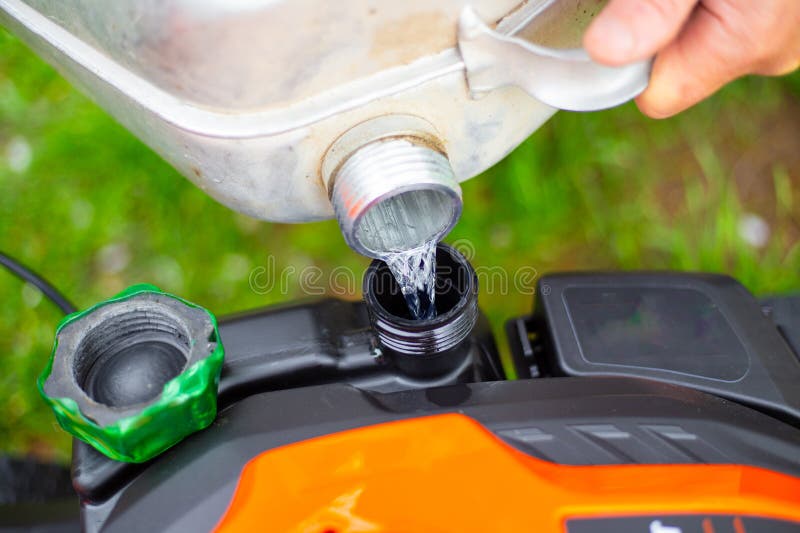 Filling a Petrol Lawn Mower with Fuel from a Canister. Preparing the ...