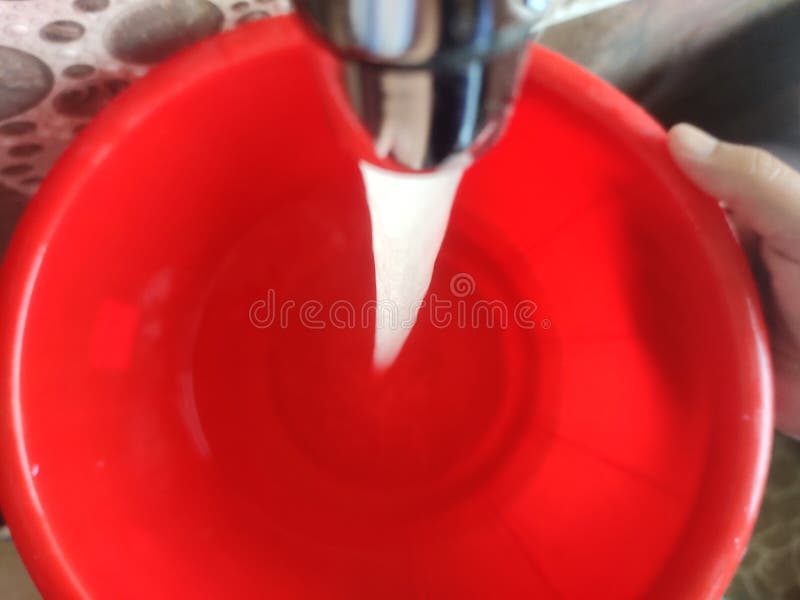 Filling Red Bucket with Tap Water for Cooking, Bathing, Cleaning. Stock ...