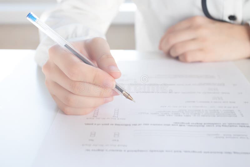 Filling the Test. Hands Hold a Pen Over Paper Stock Photo - Image of ...