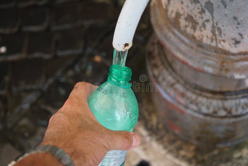 Refilling water bottle stock image. Image of bottle - 123676023