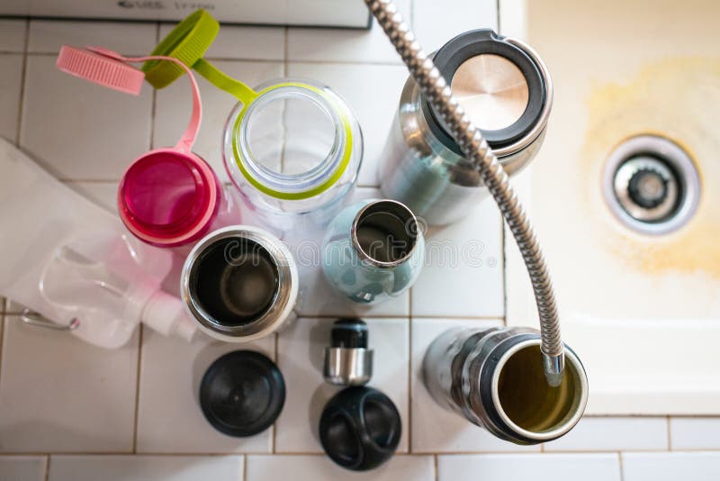 Filling Up Reuseable Water Bottles for the Family Stock Image - Image ...