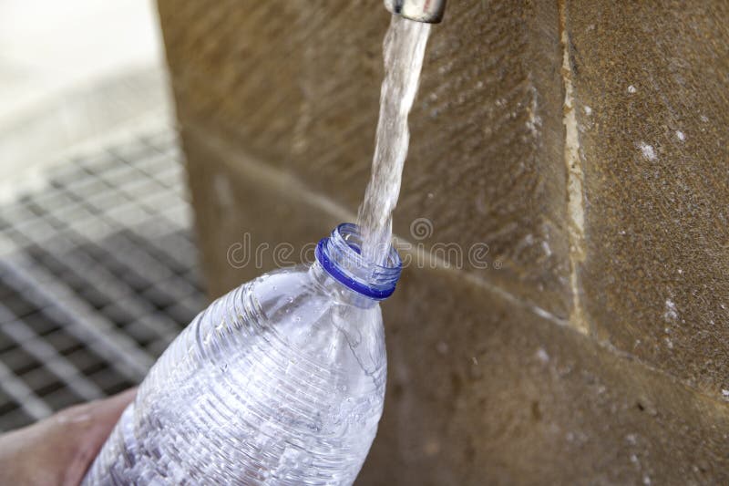 Filling a water bottle stock photo. Image of hydrate - 322964526