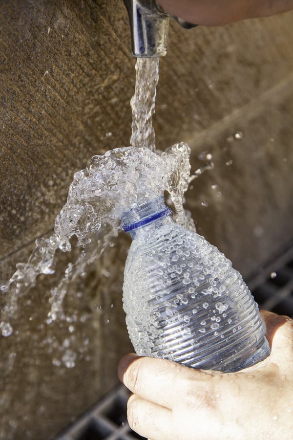 Filling water bottle stock image. Image of liquid, clear - 246869795