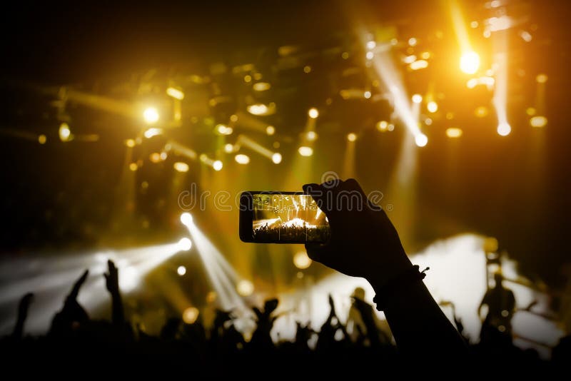 Filming a Concert on Mobile Phone Camera, Yellow Light Stock Image ...