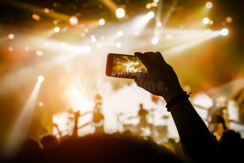 Filming a Concert on Mobile Phone Camera, Yellow Light Stock Image ...