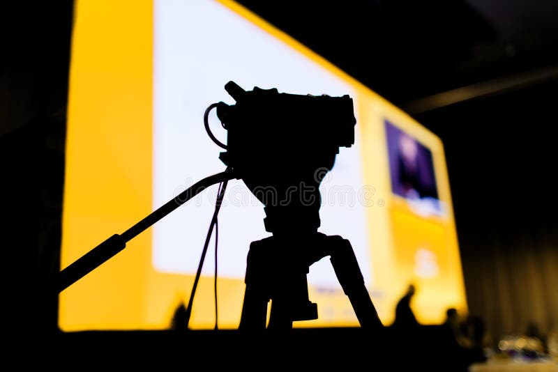 Silhouette of Small Camera from Side Against the Screen Stock Photo ...