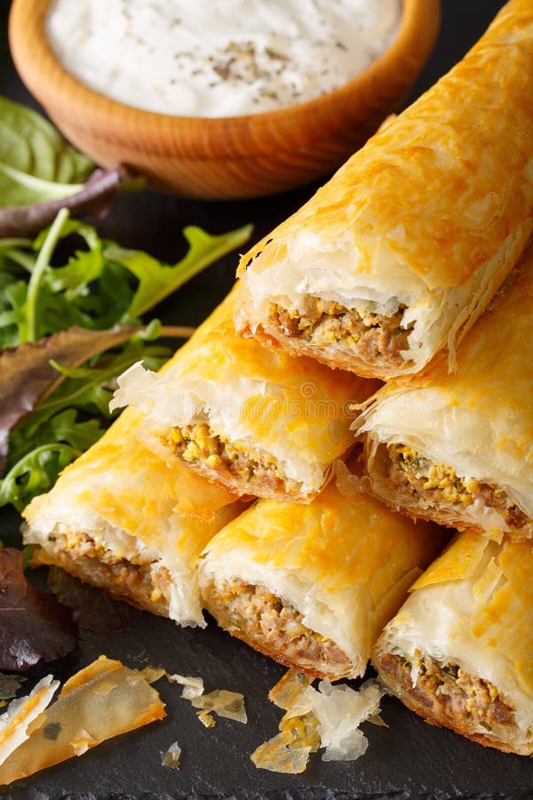 Filo Rolls with Meat, Eggs and Greens Close-up and Yogurt. Vertical ...